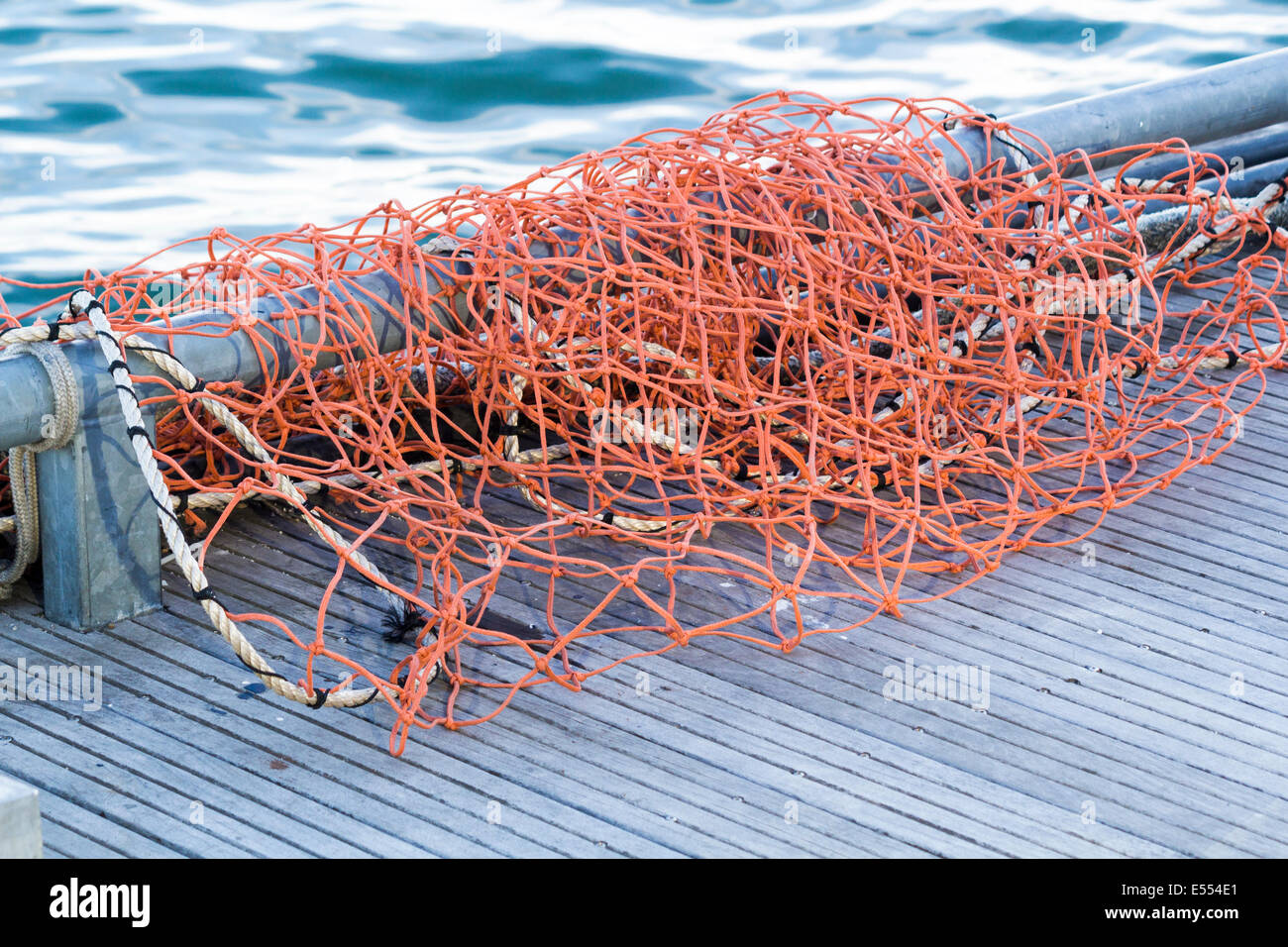 Fishing net rolled up on the dock along Lake Ontario at the waterfront ...