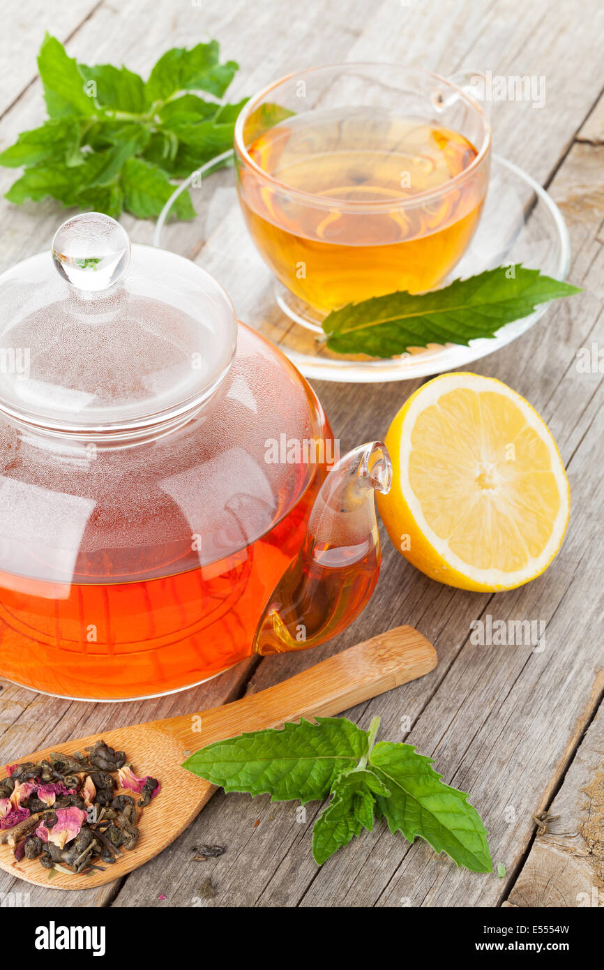 Green tea with lemon and mint on wooden table Stock Photo - Alamy