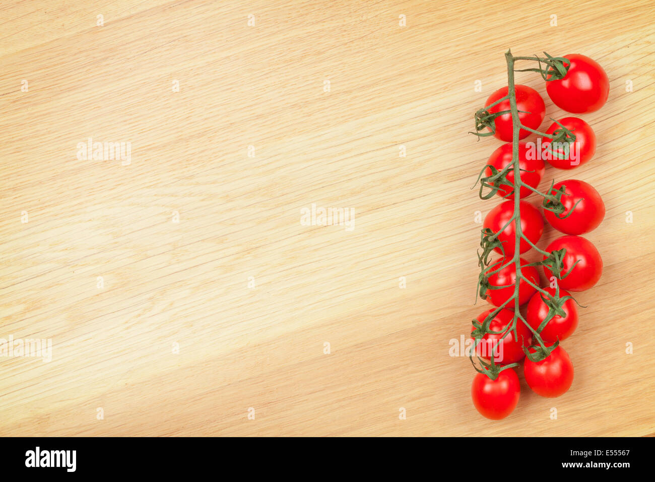 Cherry tomatoes on wooden table background with copy space Stock Photo ...