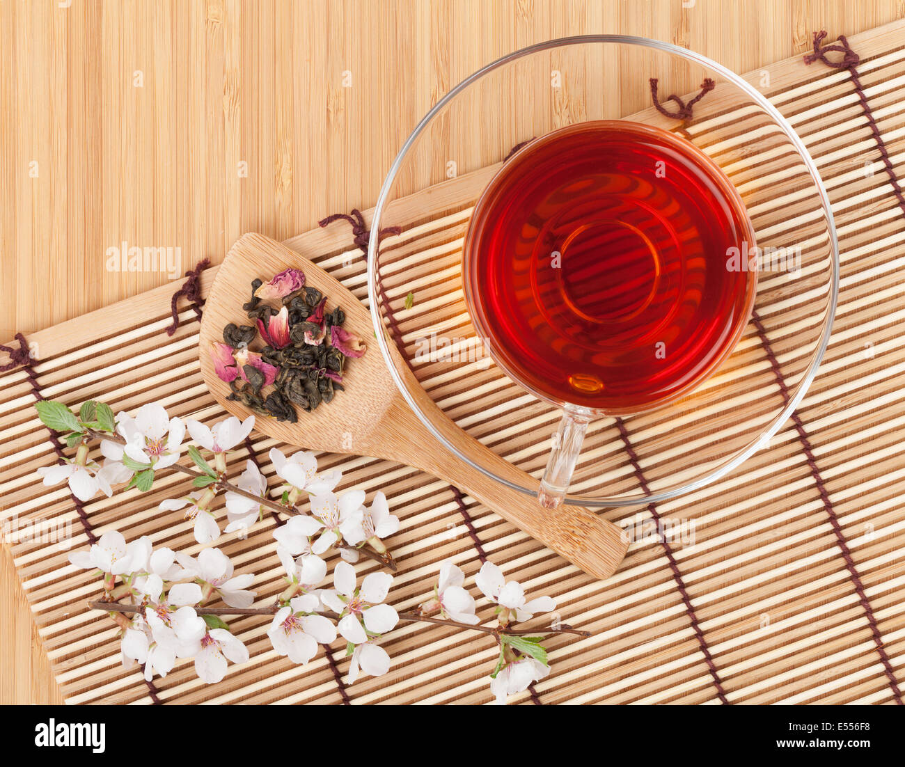 Japanese green tea and sakura branch over mat and bamboo table Stock ...