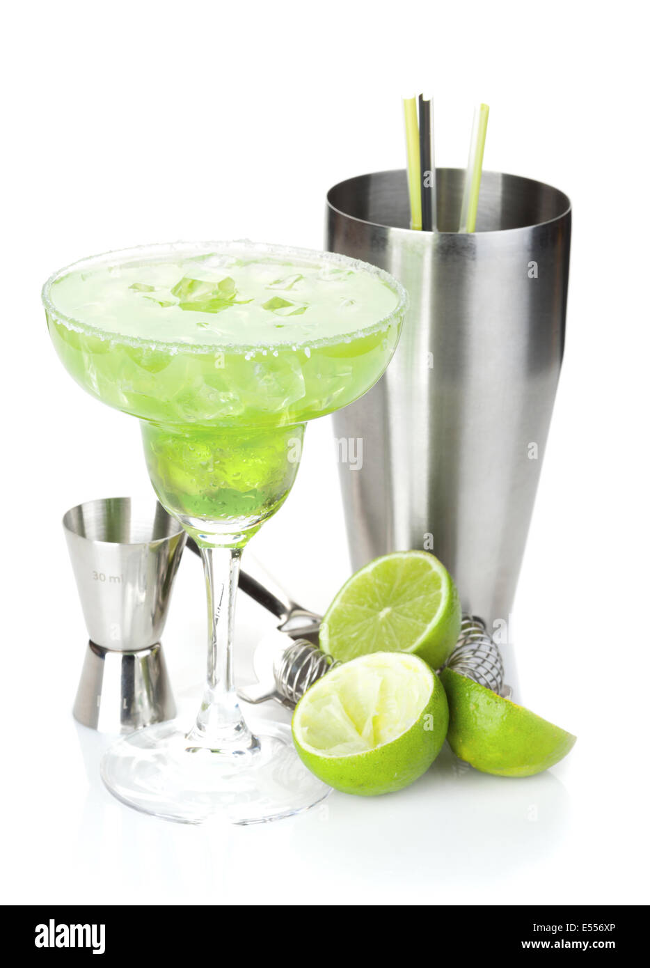 Classic margarita cocktail with salty rim, limes and drink utensils ...