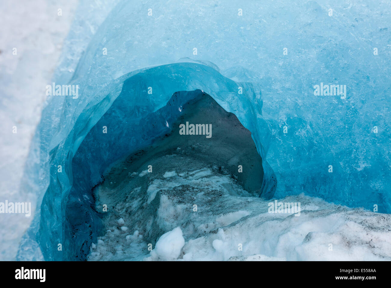 Entrance to ice cave with beautiful shades of turquoise ice at ...