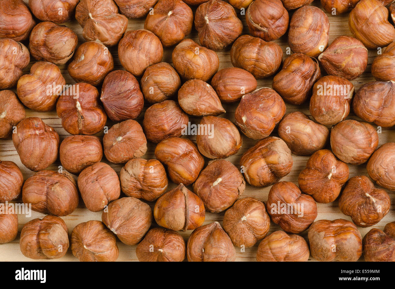 toasted hazelnuts without shells, on wood, background Stock Photo - Alamy