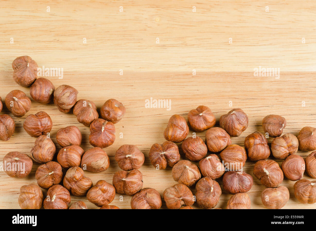 toasted hazelnuts without shells, on wood, background Stock Photo - Alamy