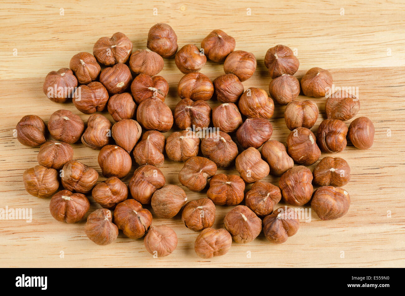 toasted hazelnuts without shells, on wood, background Stock Photo - Alamy