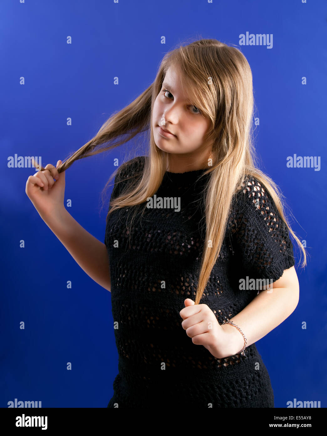 young teenage girl on blue background Stock Photo - Alamy