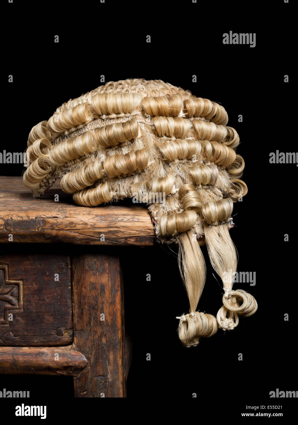 Closeup of a genuine judge's wig on an antique wooden desk Stock Photo ...