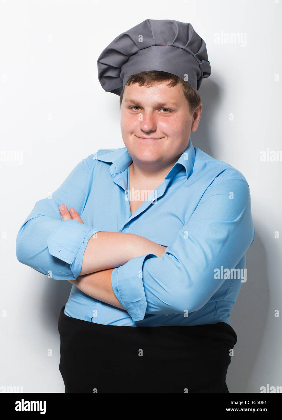 Plump cook on gray wall background Stock Photo - Alamy