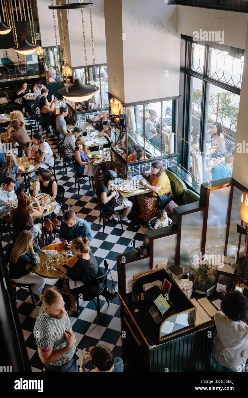 High angle view of crowded, hip restaurant with couples and groups ...
