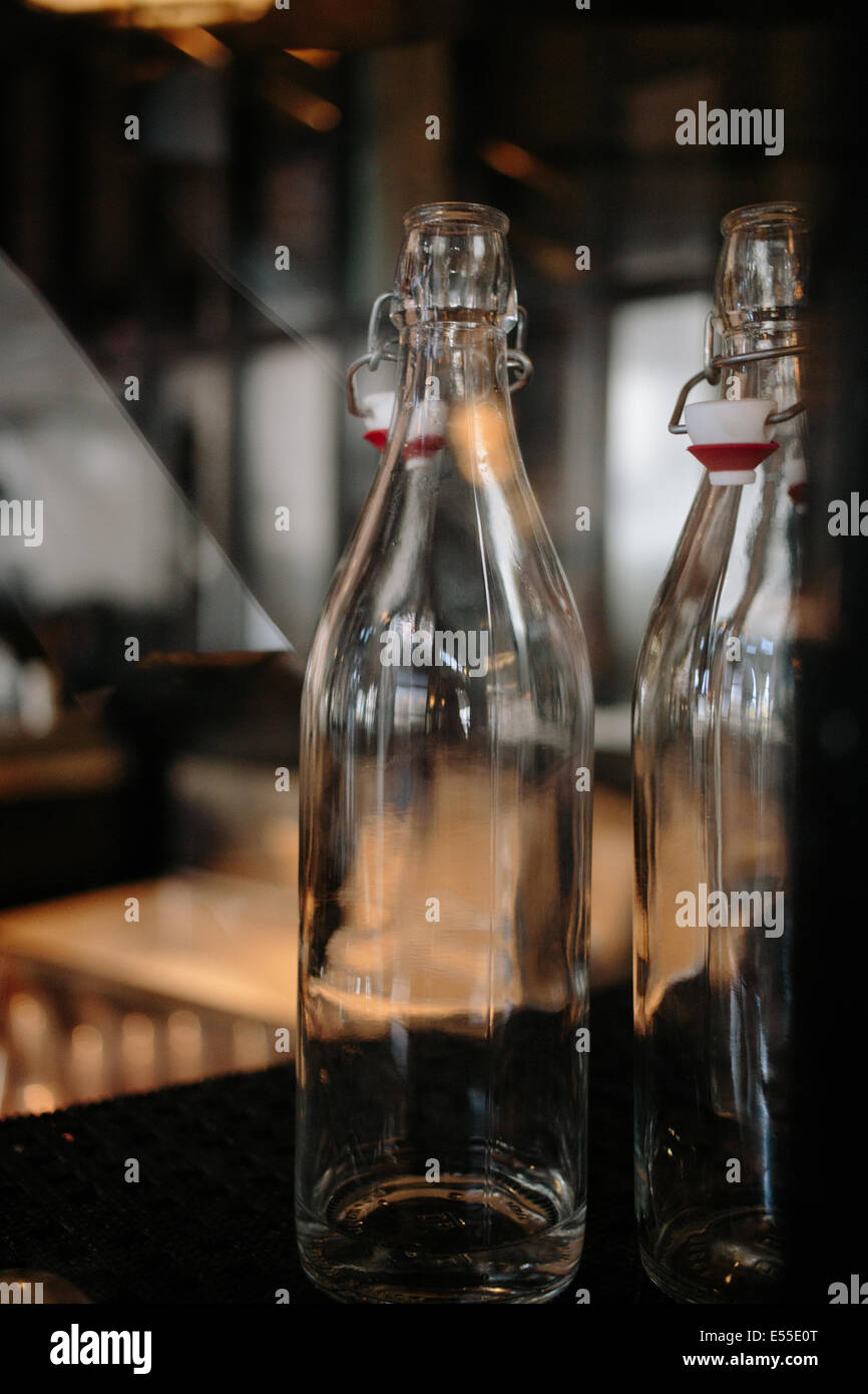 Detail shot of two empty glass bottles in cafe restaurant Stock Photo ...