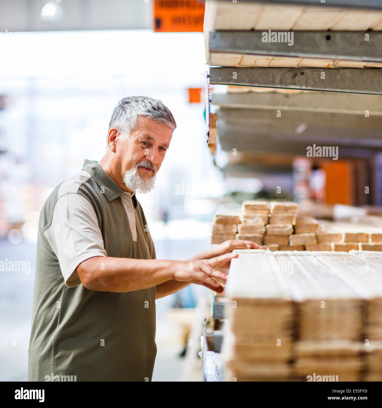 Man choosing and buying construction wood in a DIY store for his DIY ...