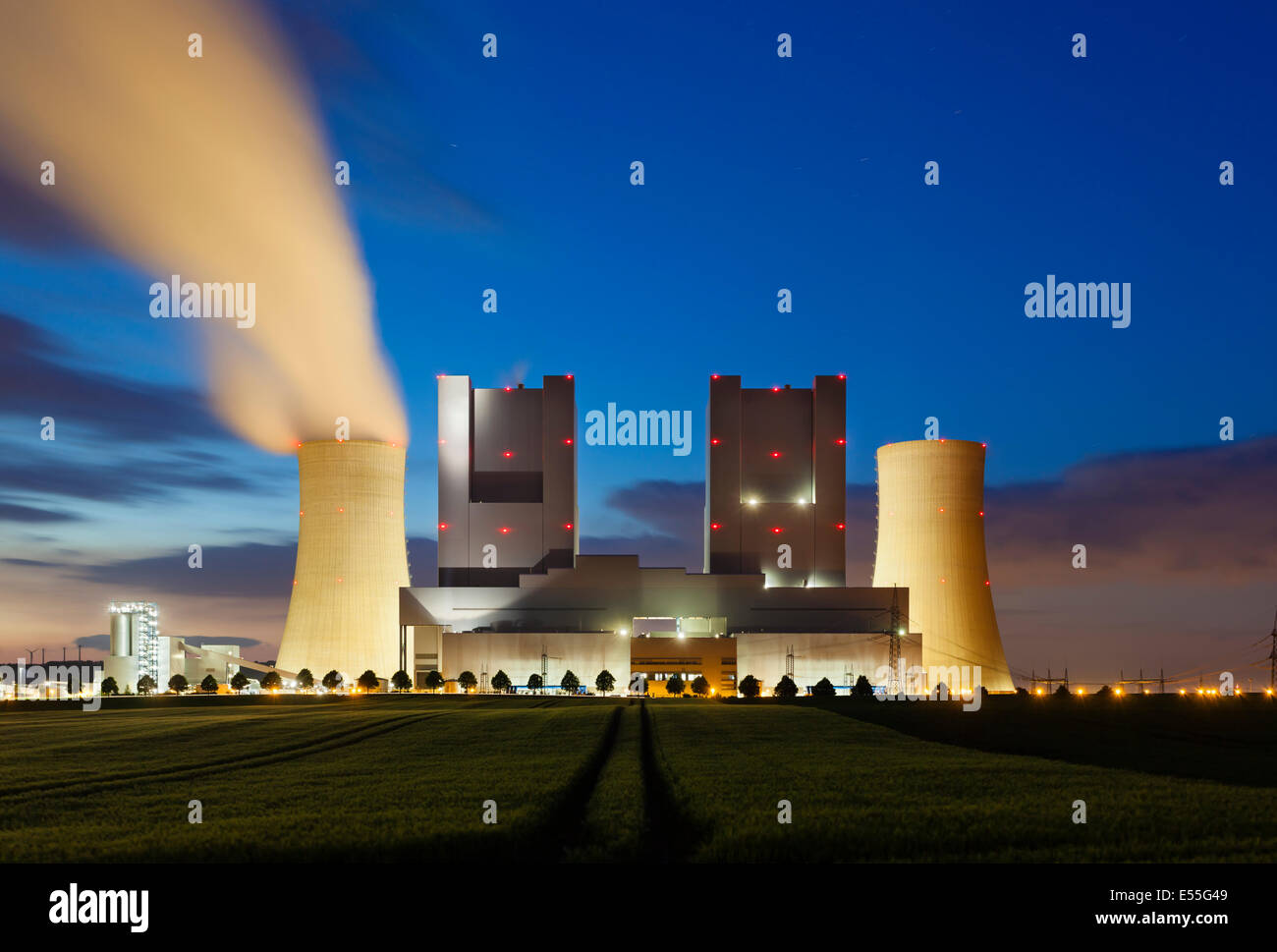 A coal-fired power station behind a field at night Stock Photo - Alamy