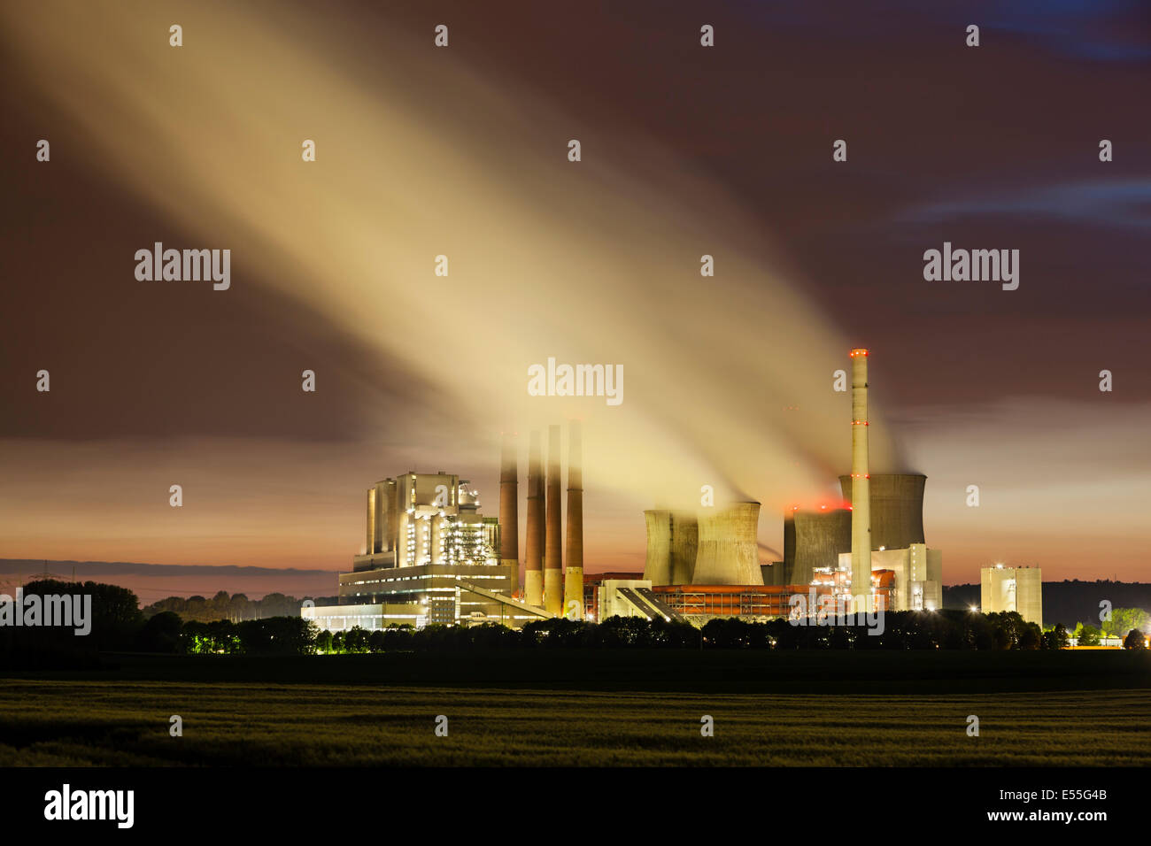 A coal-fired power station behind a field at night Stock Photo - Alamy
