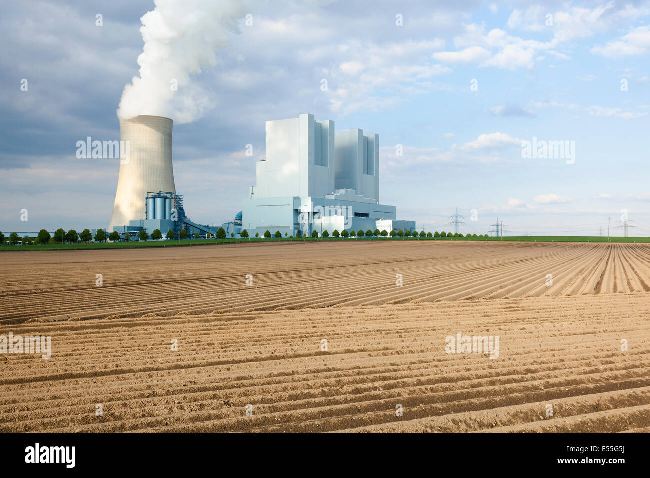 A shiny new lignite power station behind an empty field Stock Photo - Alamy