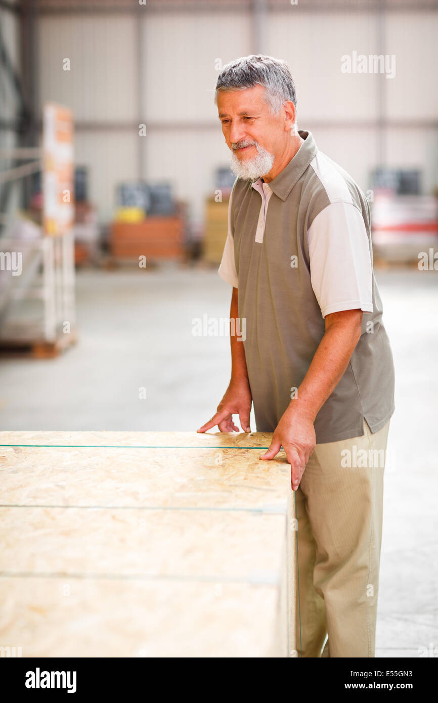 Man choosing and buying construction wood in a DIY store for his DIY ...