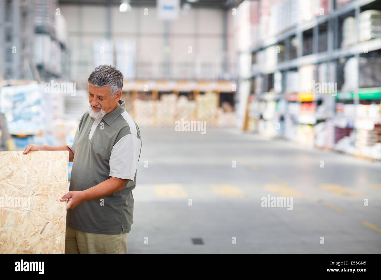 Man choosing and buying construction wood in a DIY store for his DIY ...