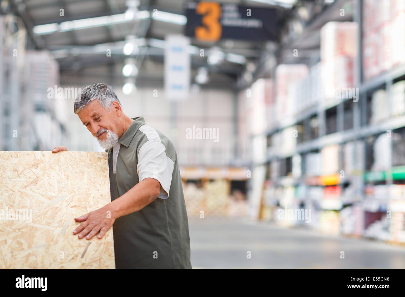 Man choosing and buying construction wood in a DIY store for his DIY ...