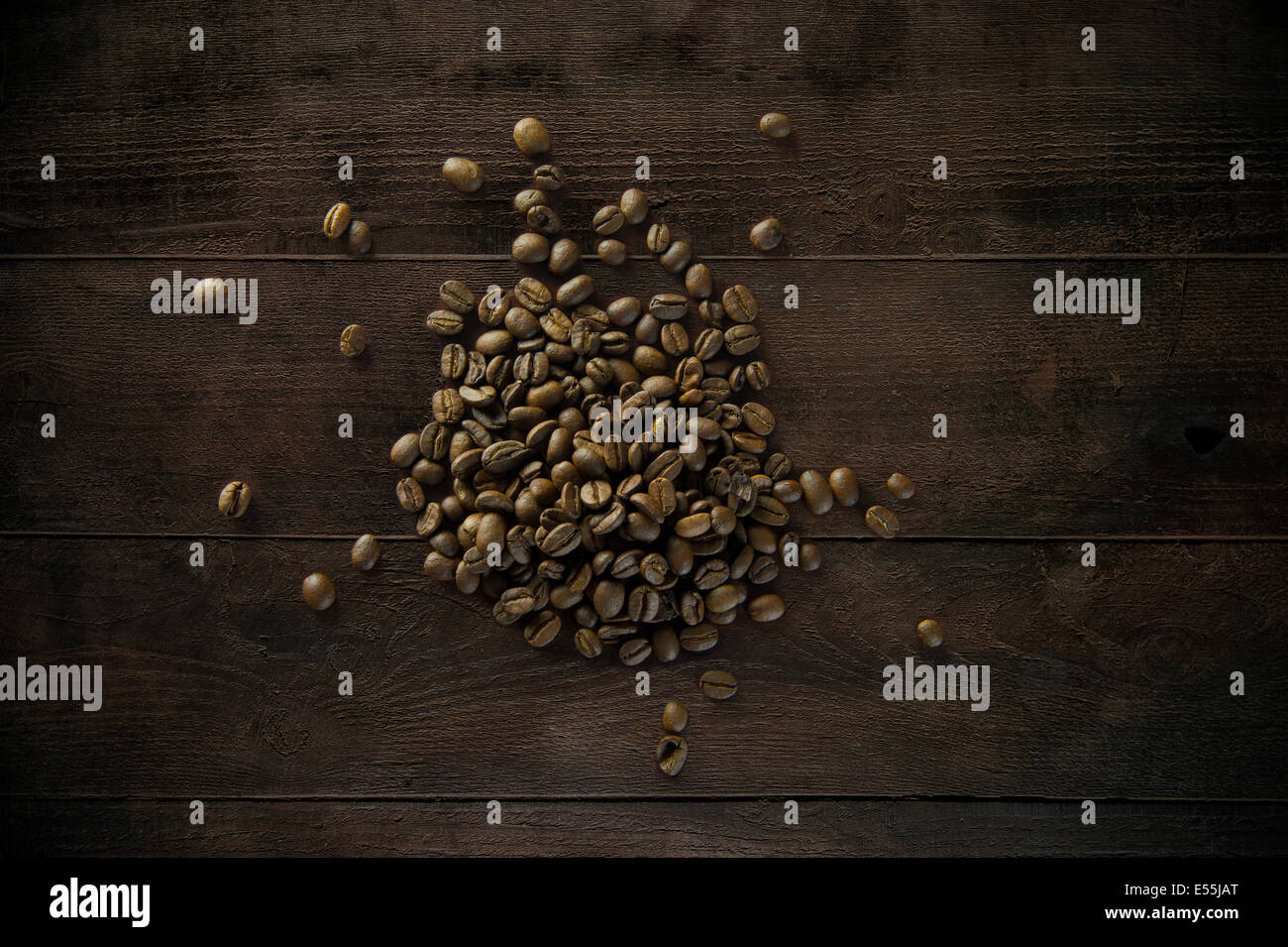 Coffee beans on old wooden texture Stock Photo - Alamy