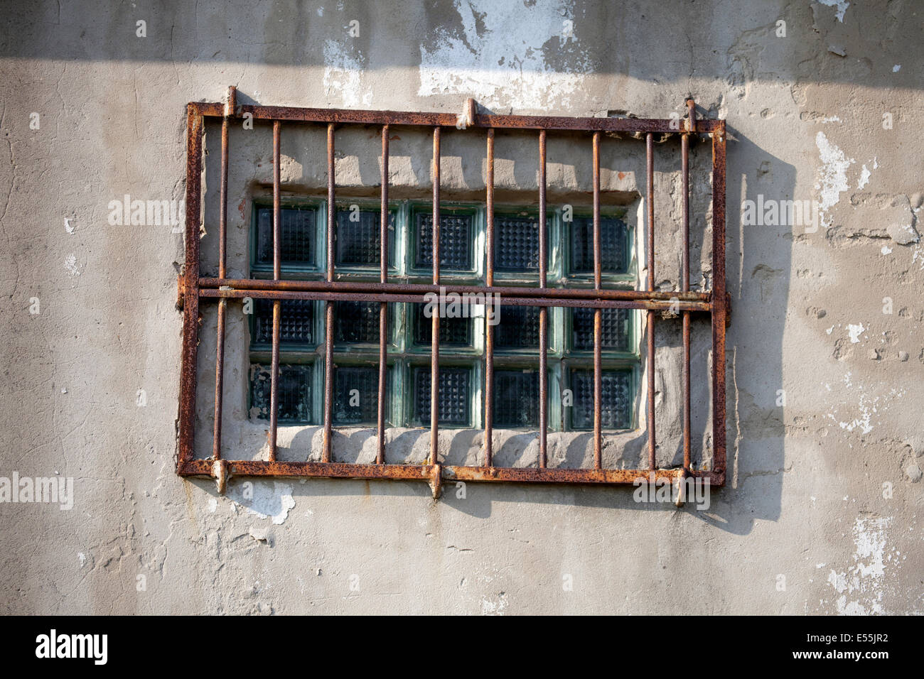 Iron bars covering back window of village grocery store. Mala Wola ...