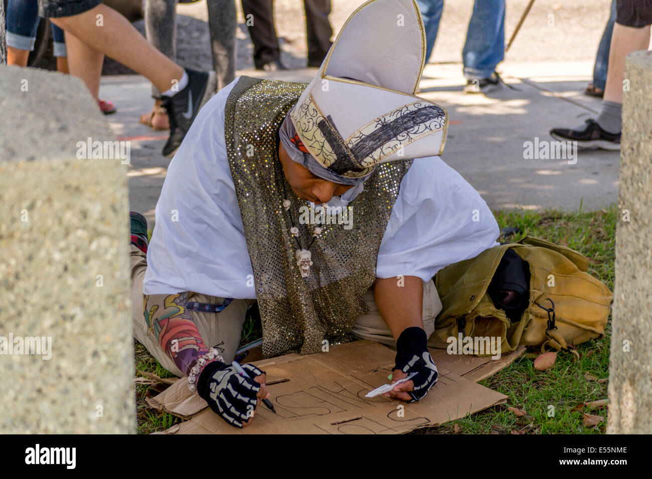 Protester dressed as the Pope wearing a skull mask making a protest ...