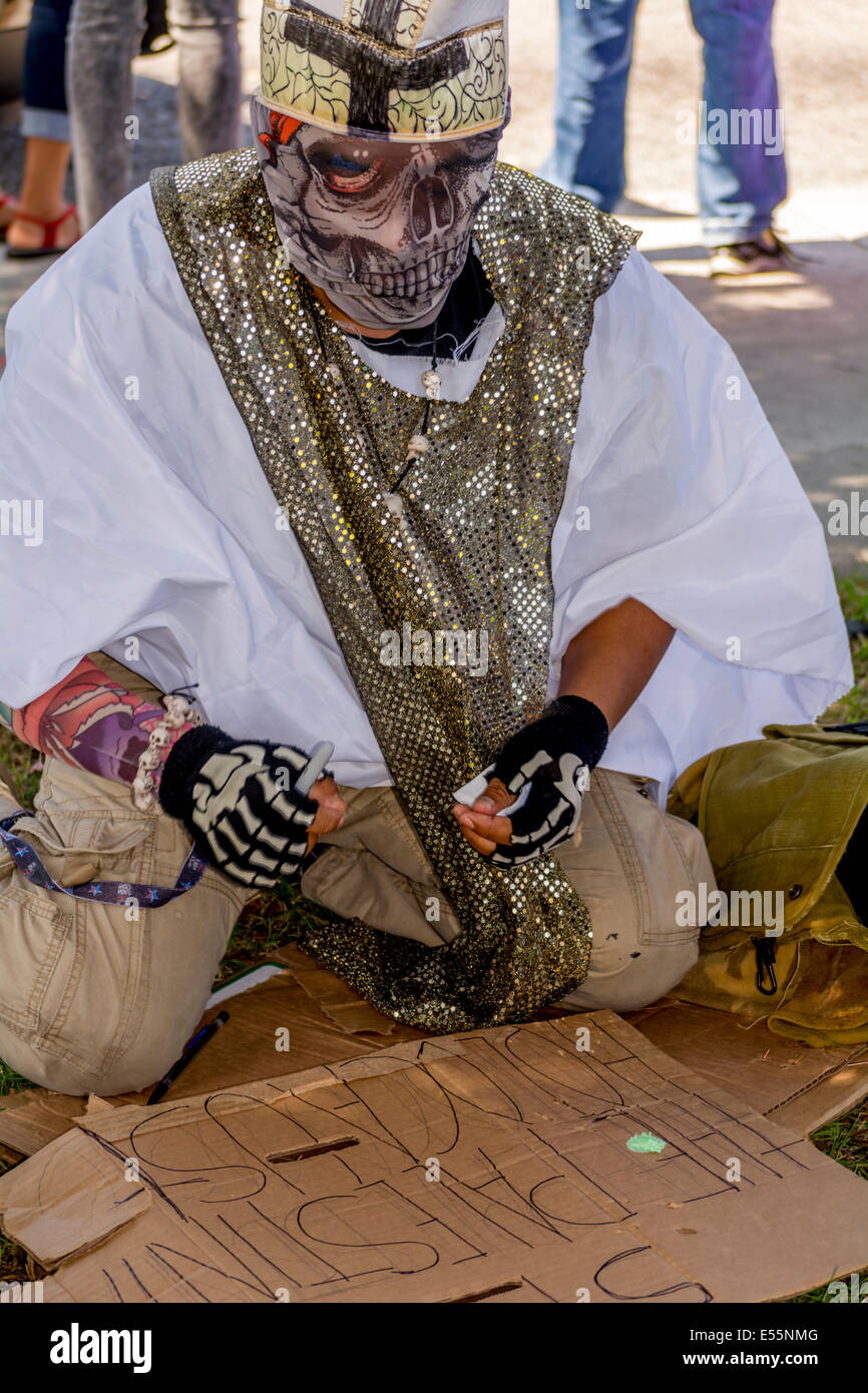 Protester dressed as the Pope wearing a skull mask making a protest ...