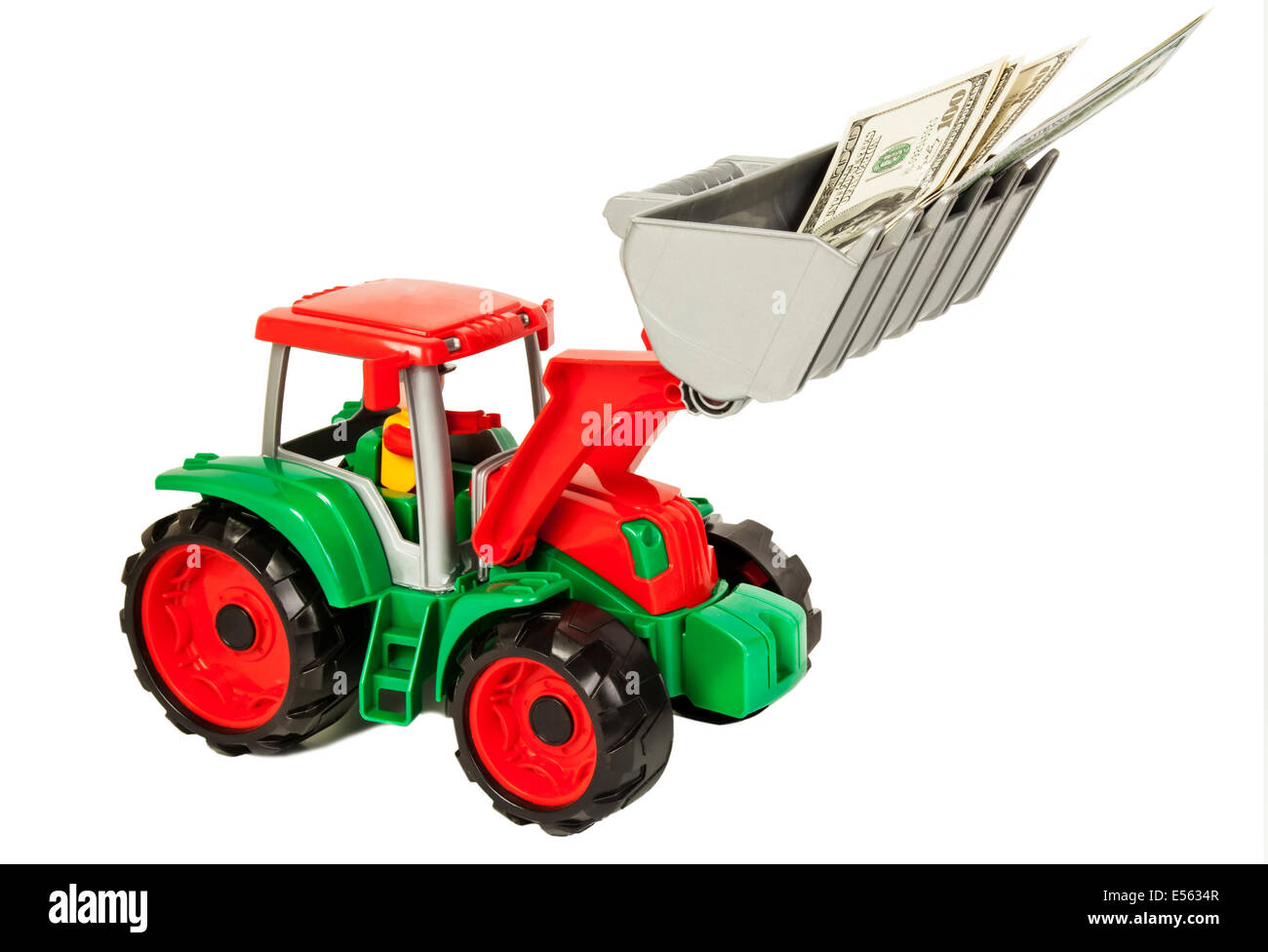 Red and green toy bulldozer with dollars Stock Photo - Alamy