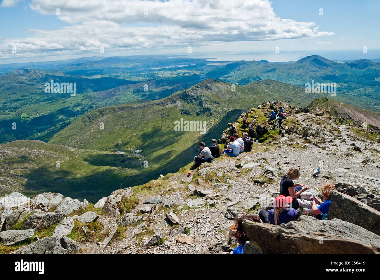 Walkers take a break to admire the view from the summit of Mount ...