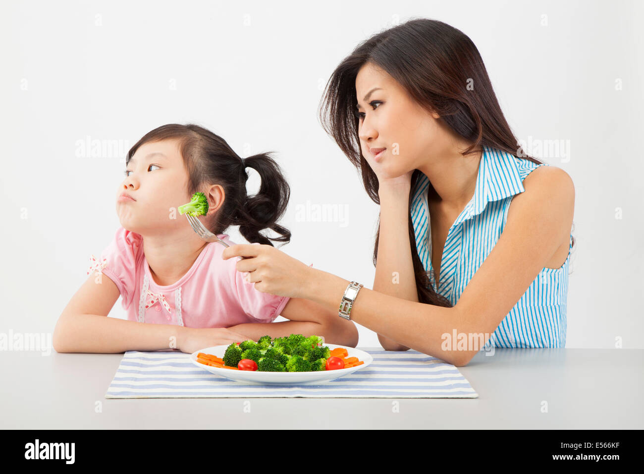 Asian Chinese kid refuses to eat vegetables Stock Photo - Alamy