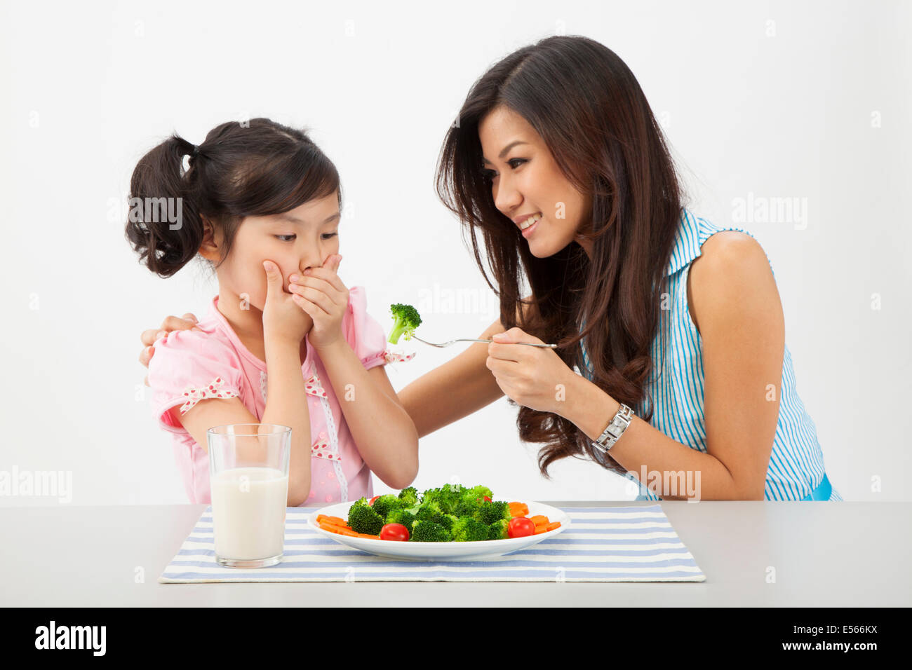 Young chinese mother feeding her kid with vegetables Stock Photo - Alamy Young chinese mother feeding her kid with vegetables Stock Photo - Alamy