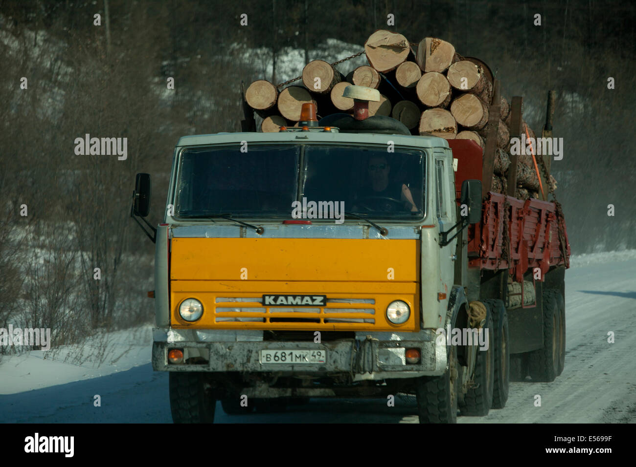 Russian timber truck logs snow road Stock Photo - Alamy