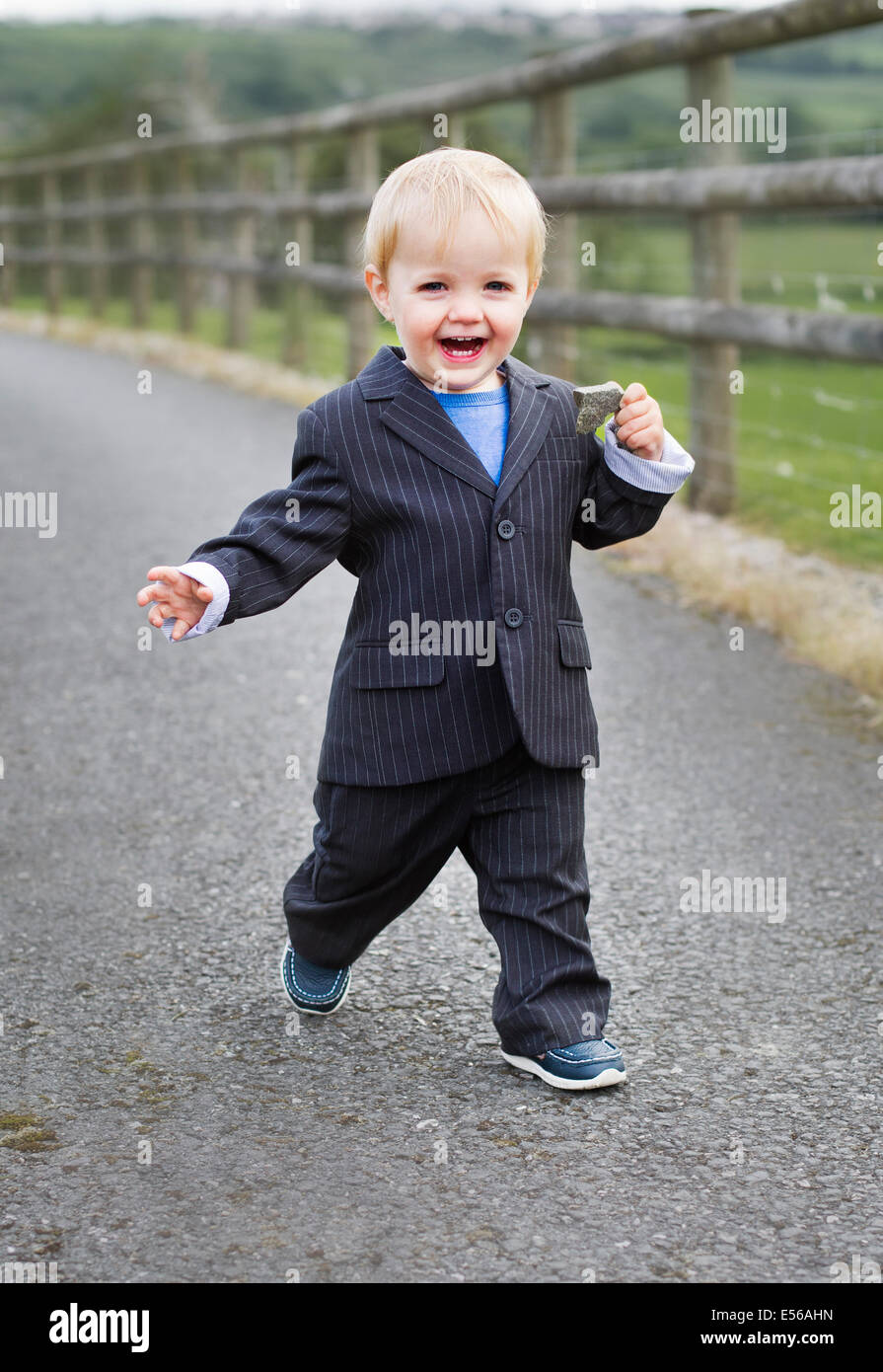 A happy little boy running and smiling Stock Photo - Alamy