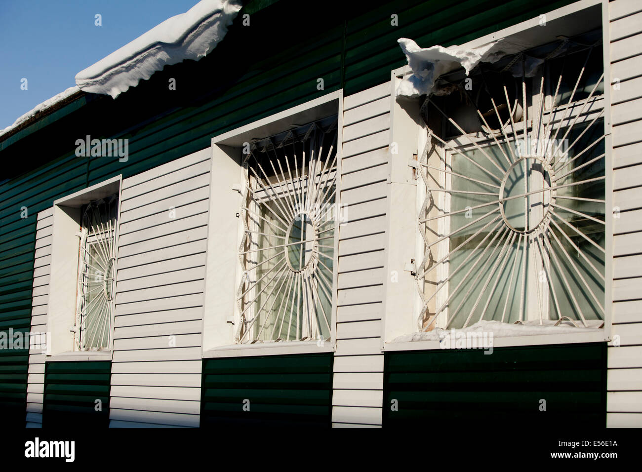 Ornate Russian window grills three window snow Stock Photo - Alamy