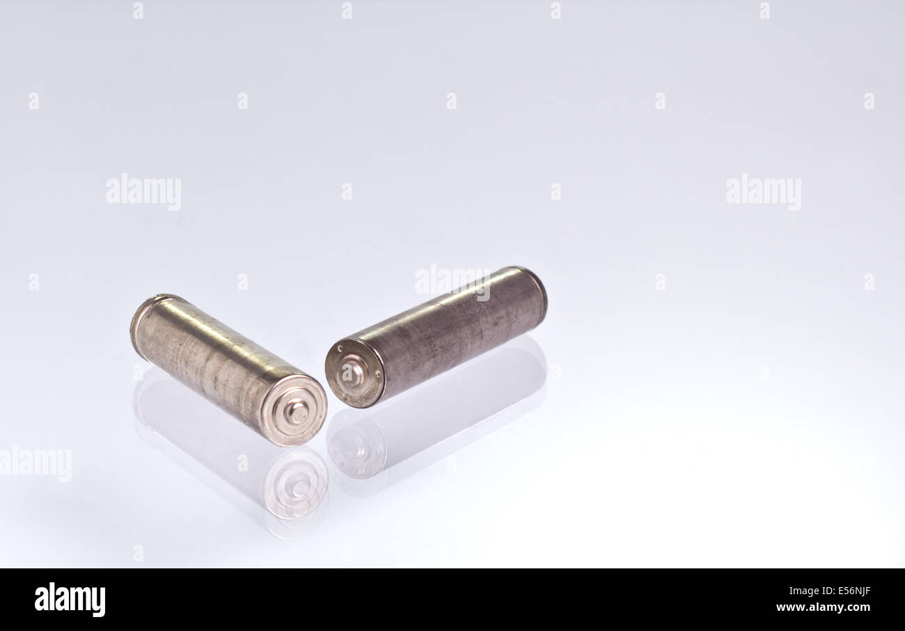 two of uncovered batteries on isolate white background Stock Photo - Alamy
