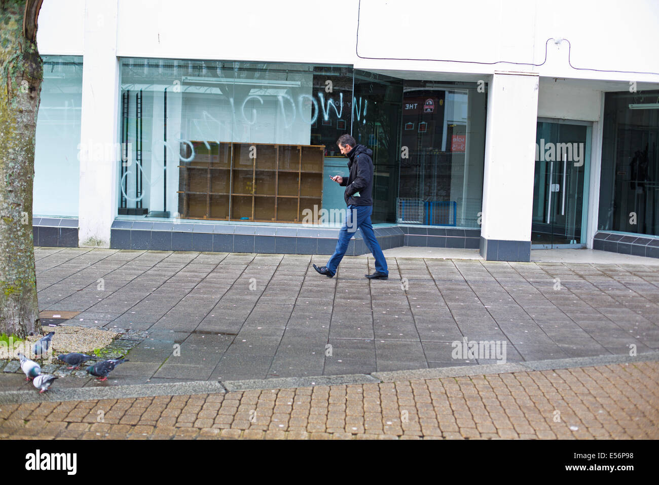 A run down street in Plymouth showing empty closed down shops Stock ...