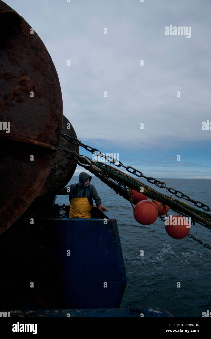 Fisherman hauling back dragger net on fishing trawler. Stellwagen Bank ...