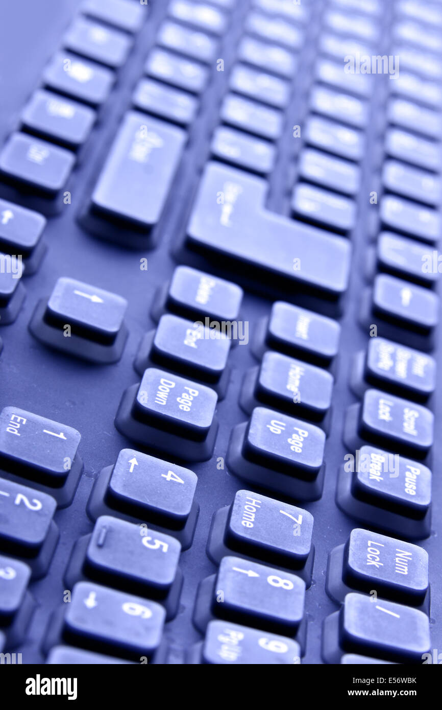 Computer keyboard close up in blue light Stock Photo - Alamy