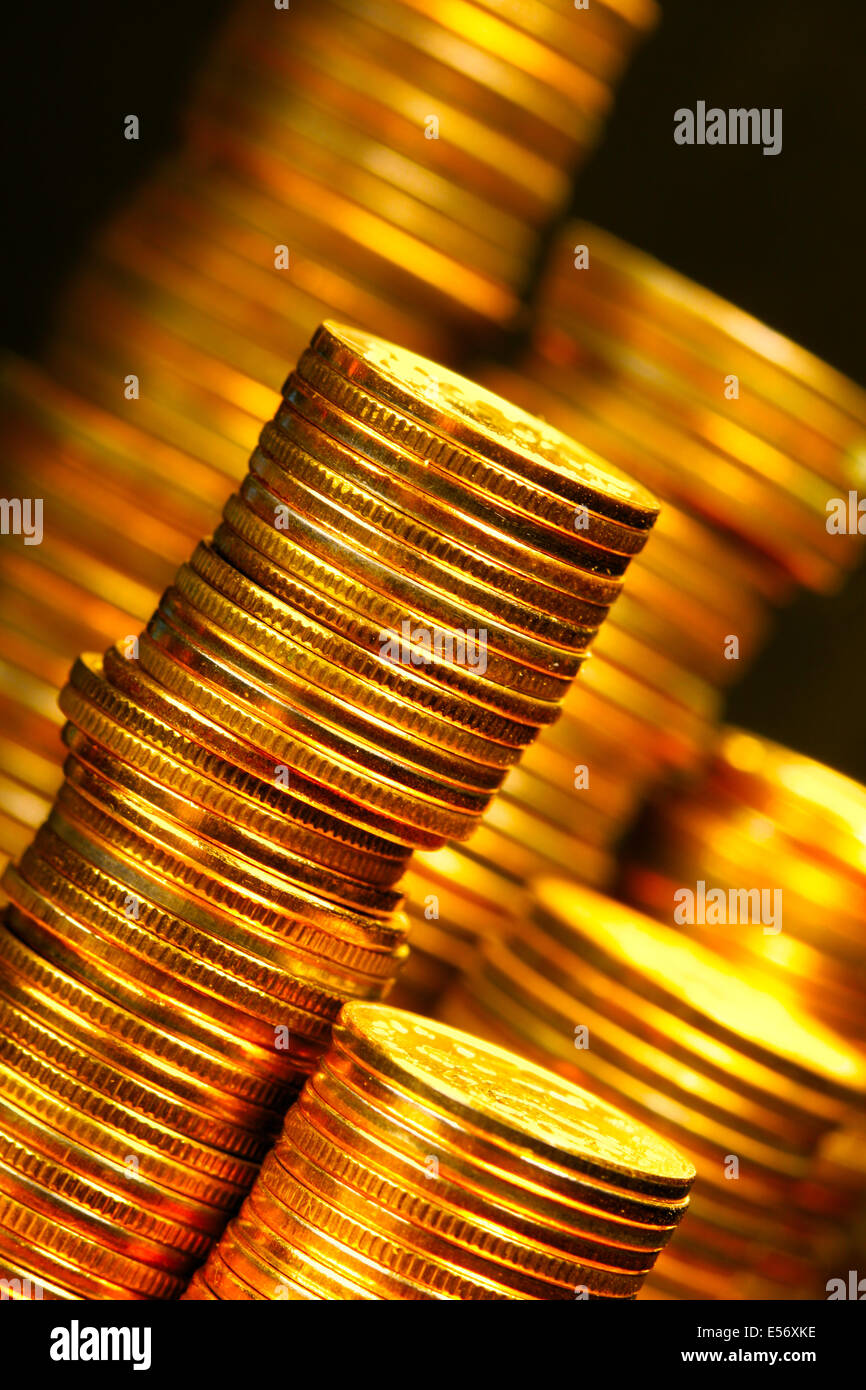 Coins stacks close up over black background Stock Photo - Alamy