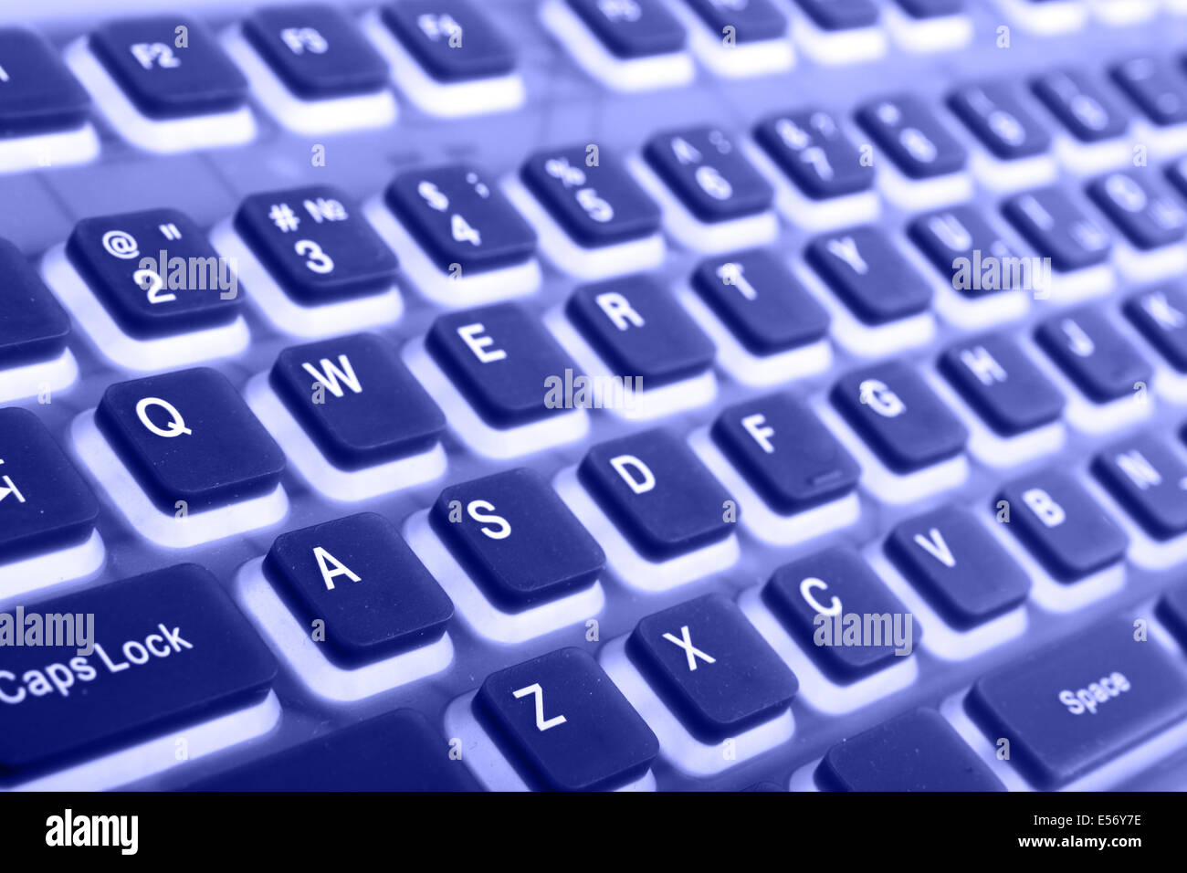 Keyboard close-up toned in blue color Stock Photo - Alamy
