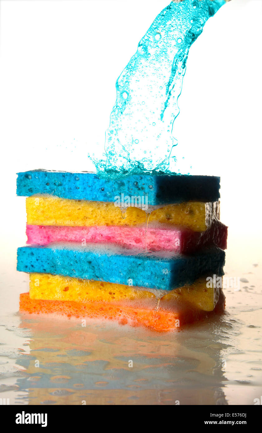 Mulit Colored Sponges Stacked on top of one another with Splash Stock ...