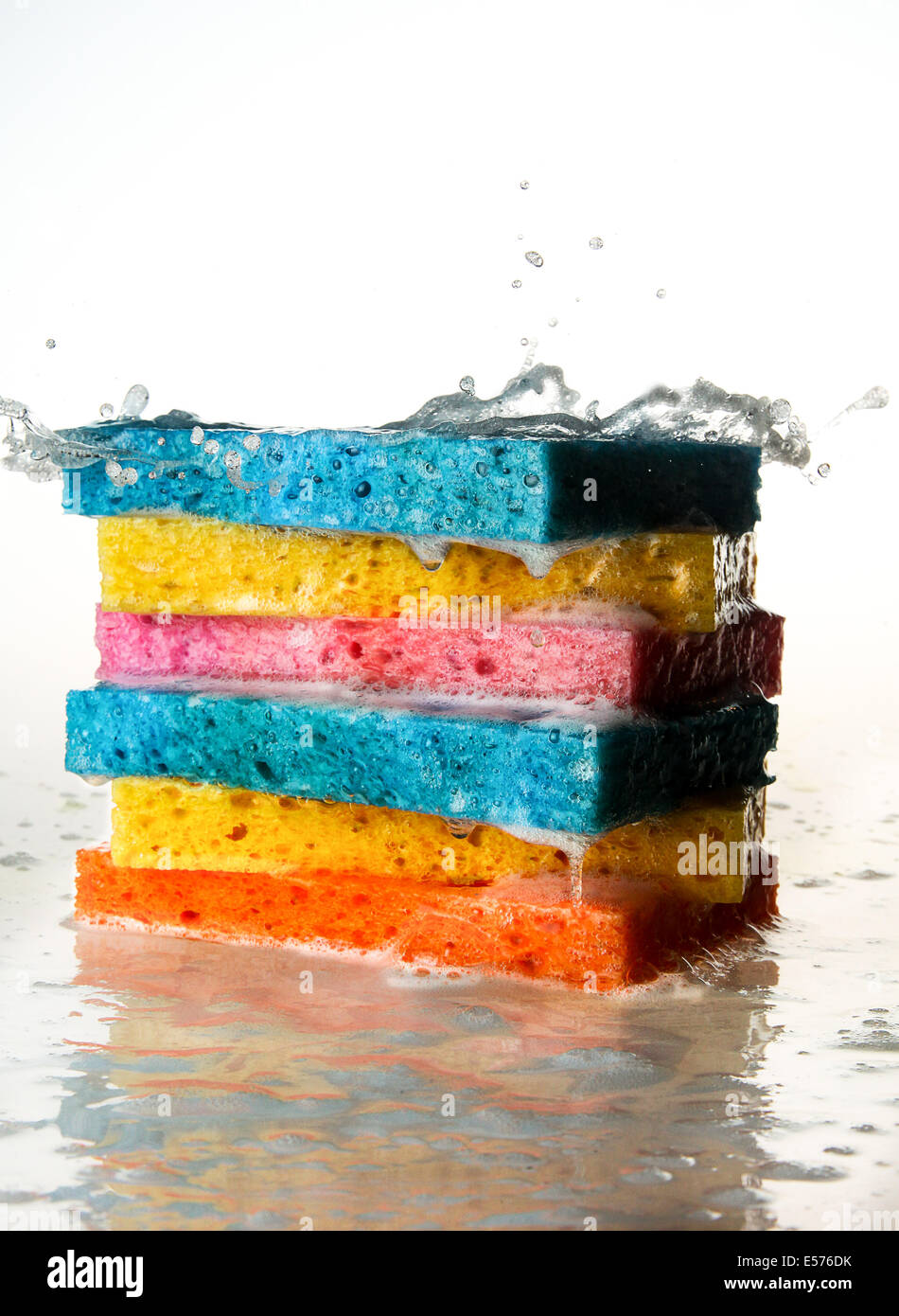 Mulit Colored Sponges Stacked on top of one another with Splash Stock ...