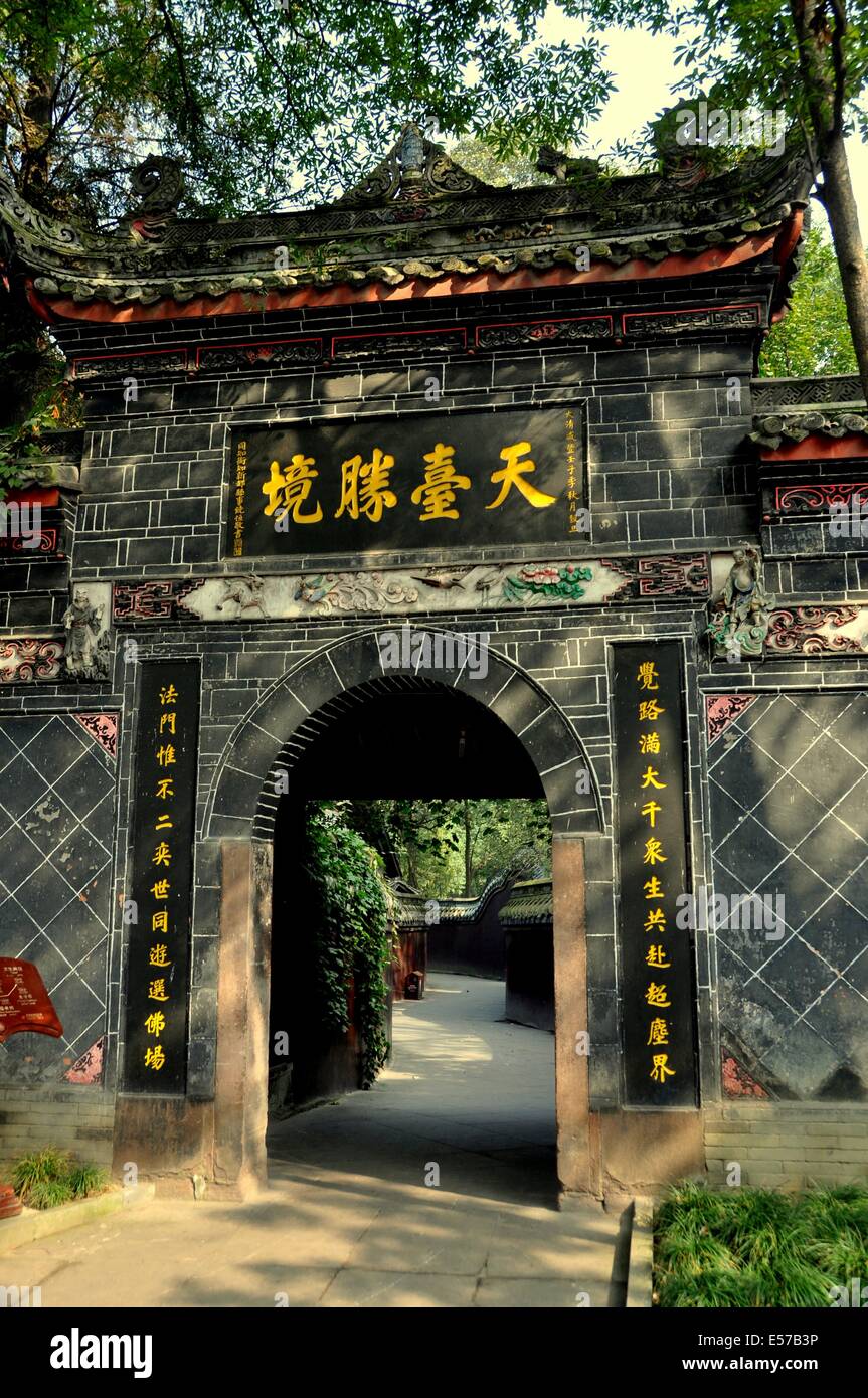 XINDU, CHINA: A handsome stone gateway leads from a center courtyard to ...
