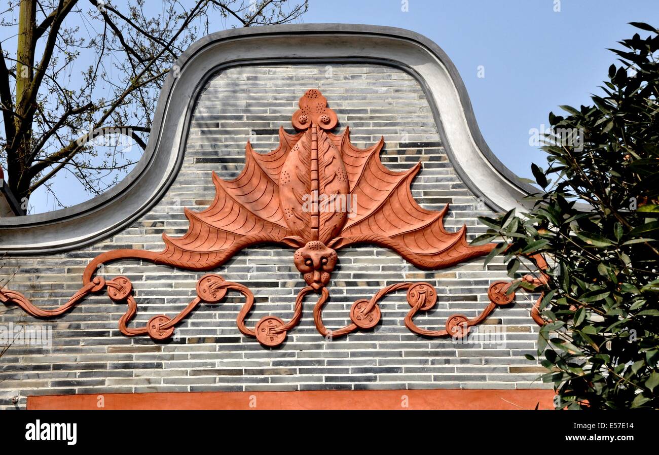 XIN XING ZHEN, CHINA: A terra cotta symbol of a bat graces a brick ...