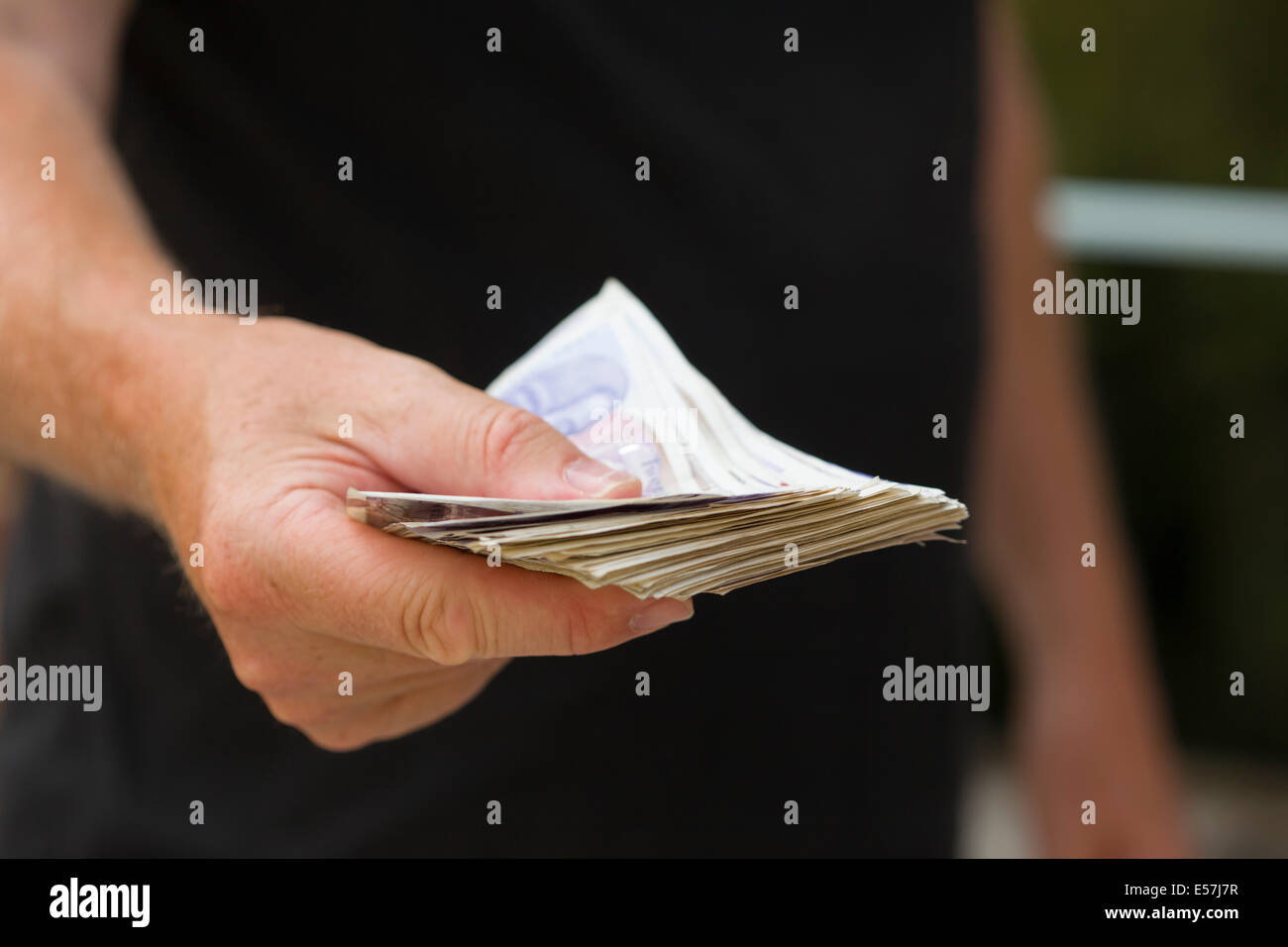 Handing over UK cash notes. Counting money maybe about to pay in cash ...