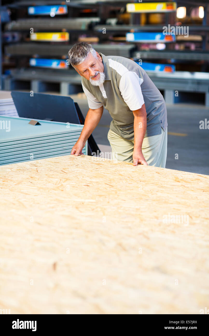 Man choosing and buying construction wood in a DIY store for his DIY ...