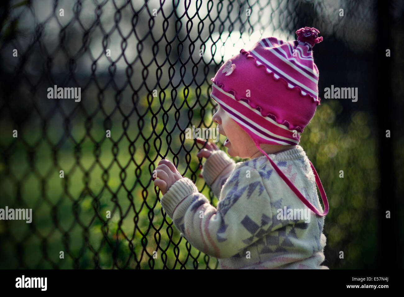 Little child behind a fence Stock Photo - Alamy