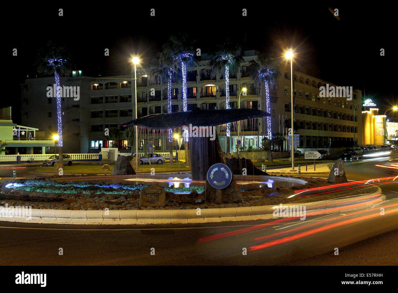 A sculpture of a whale's tail and water pool, on a roundabout, shot at ...