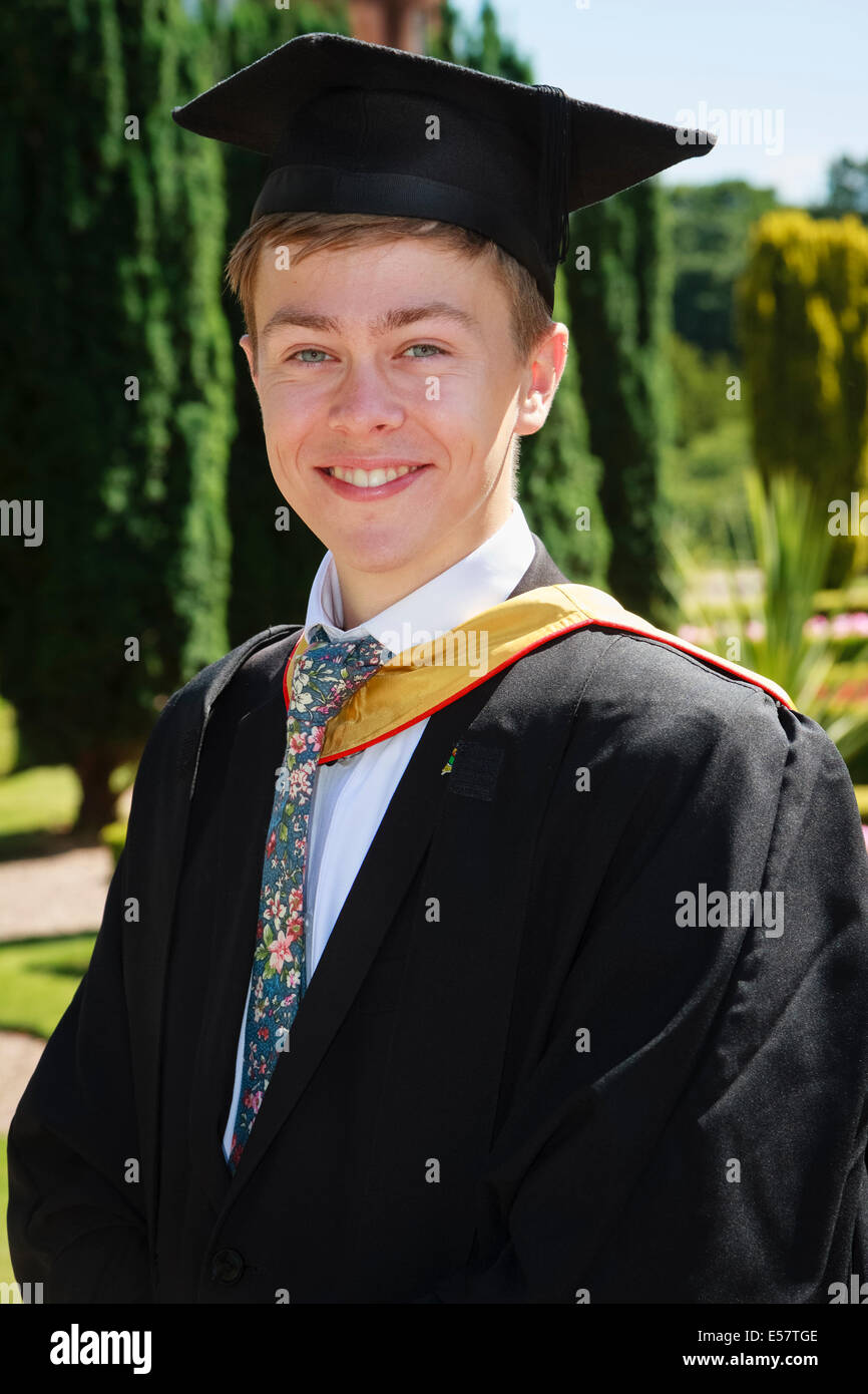 University student poses in traditional mortar board and gown on ...