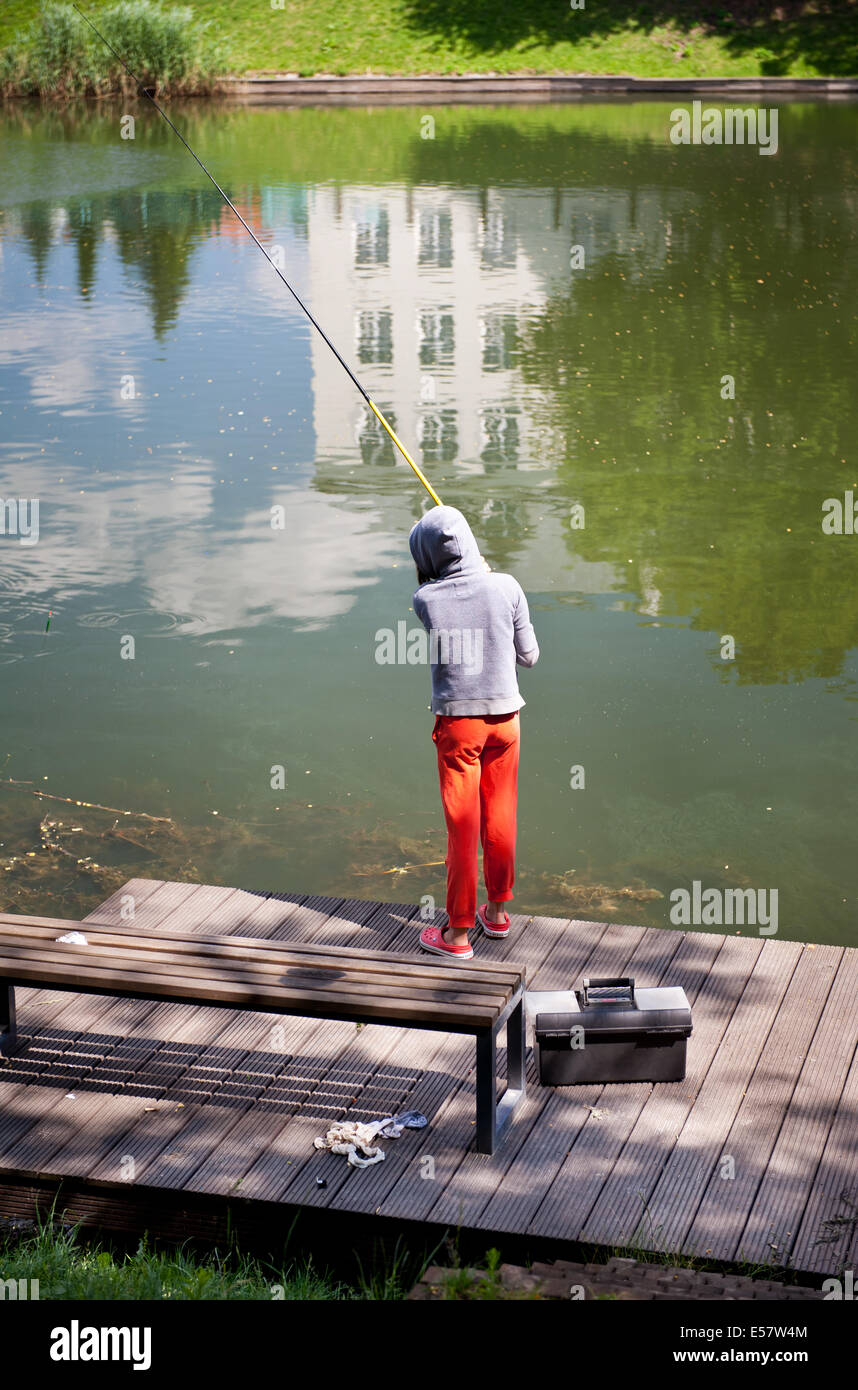 Child fishing on wooden bridge Stock Photo - Alamy