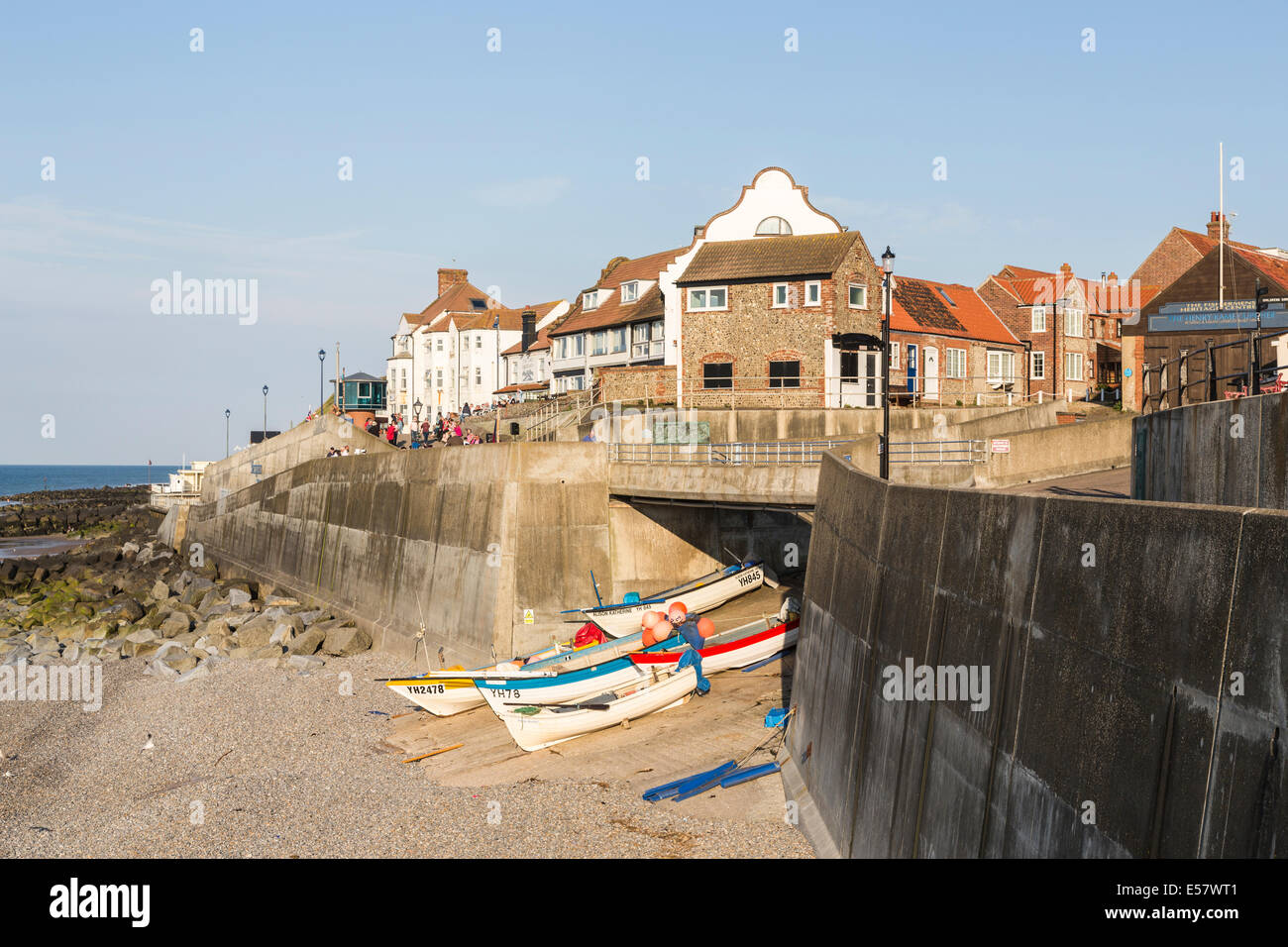 Colourful rowing boats on the beach of the seaside town of Sheringham ...