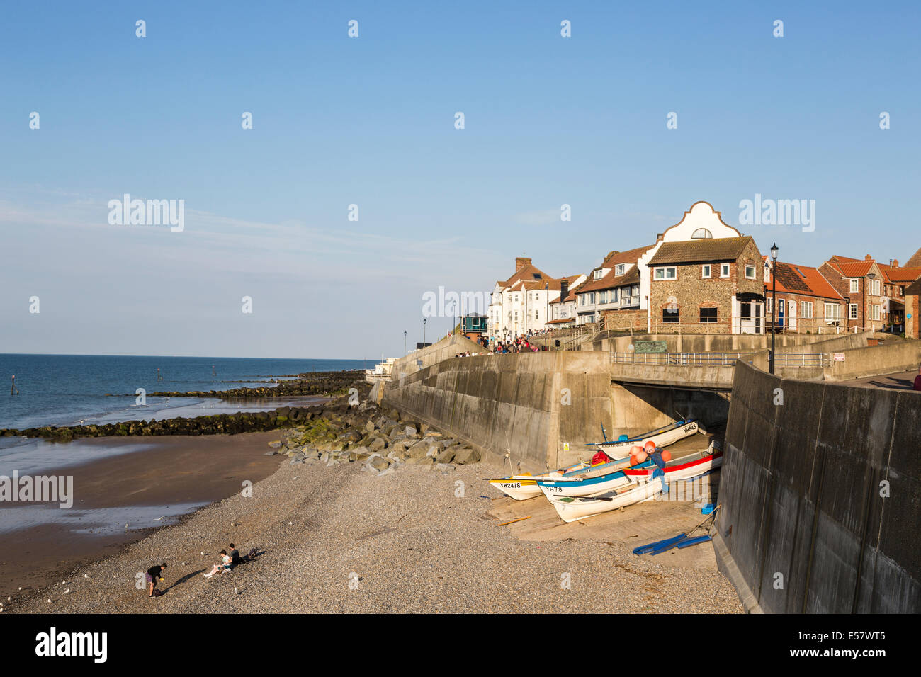 Colourful rowing boats on the beach of the seaside town of Sheringham ...